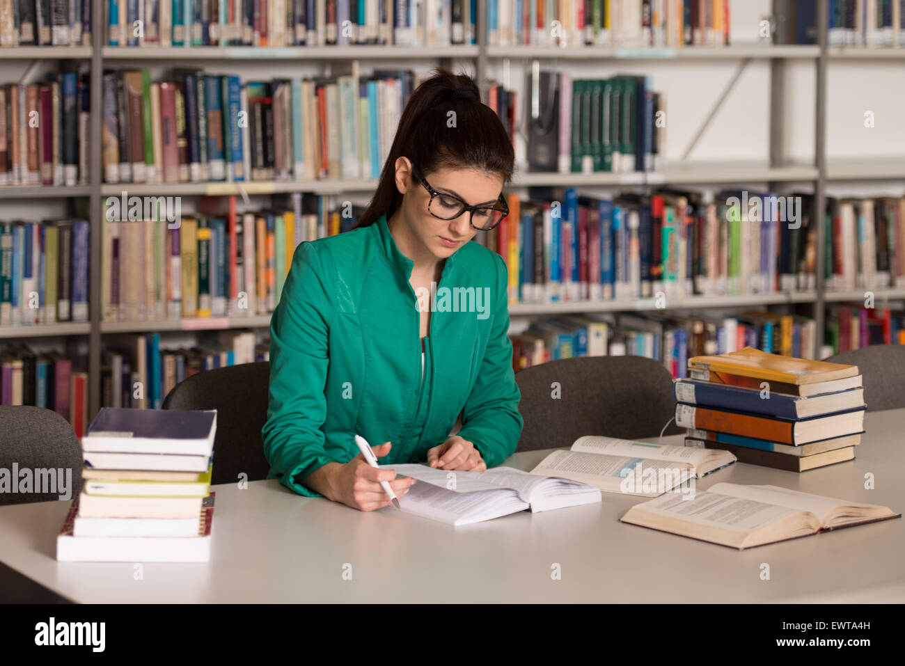 Portrait Of Clever Student With Open Book Reading It In College Library ...