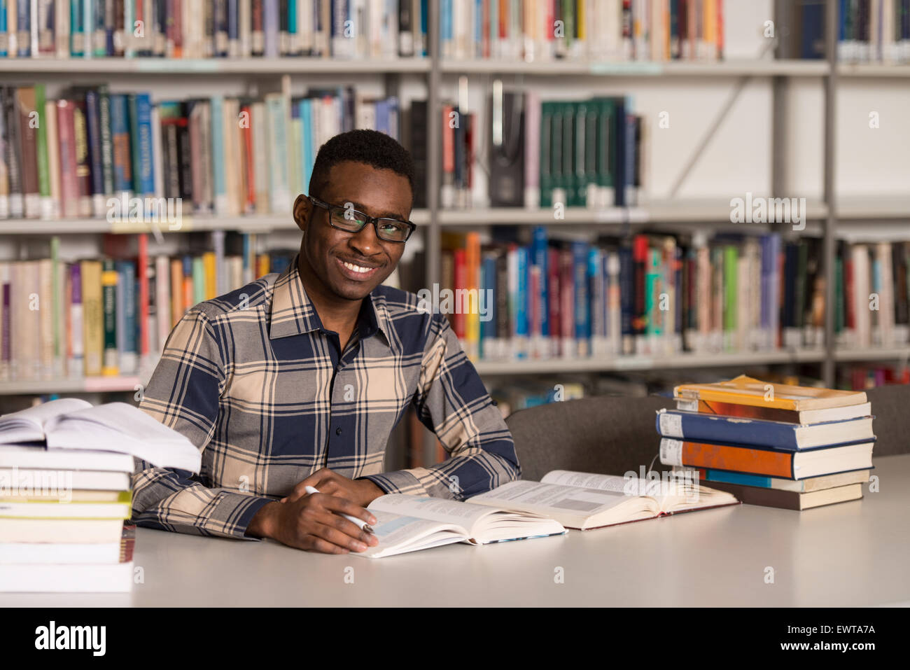 Portrait Of African Clever Student With Open Book Reading It In College ...
