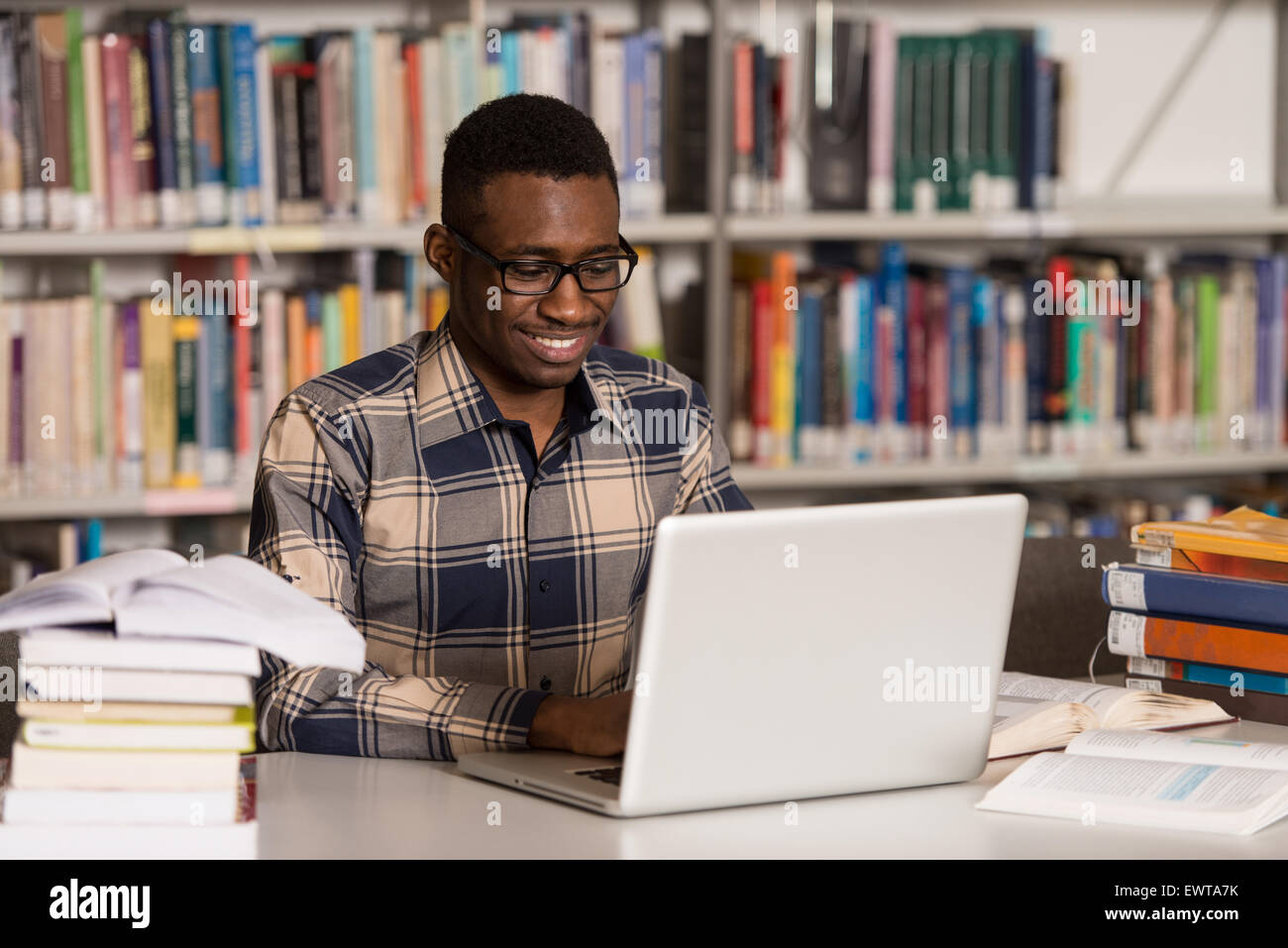 In The Library - Handsome African Male Student With Laptop And Books ...
