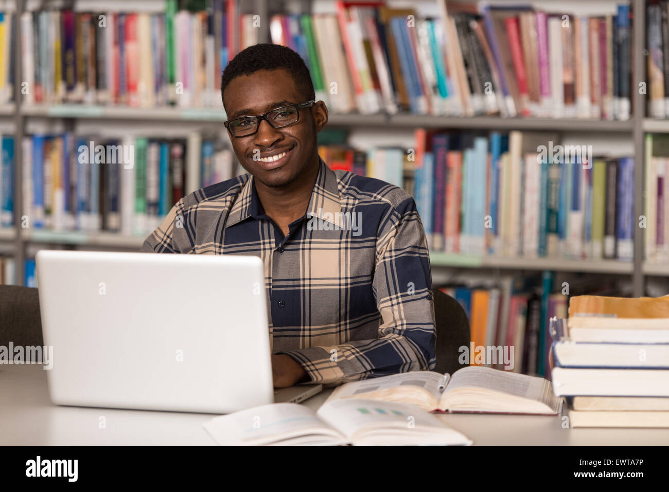 In The Library - Handsome African Male Student With Laptop And Books ...