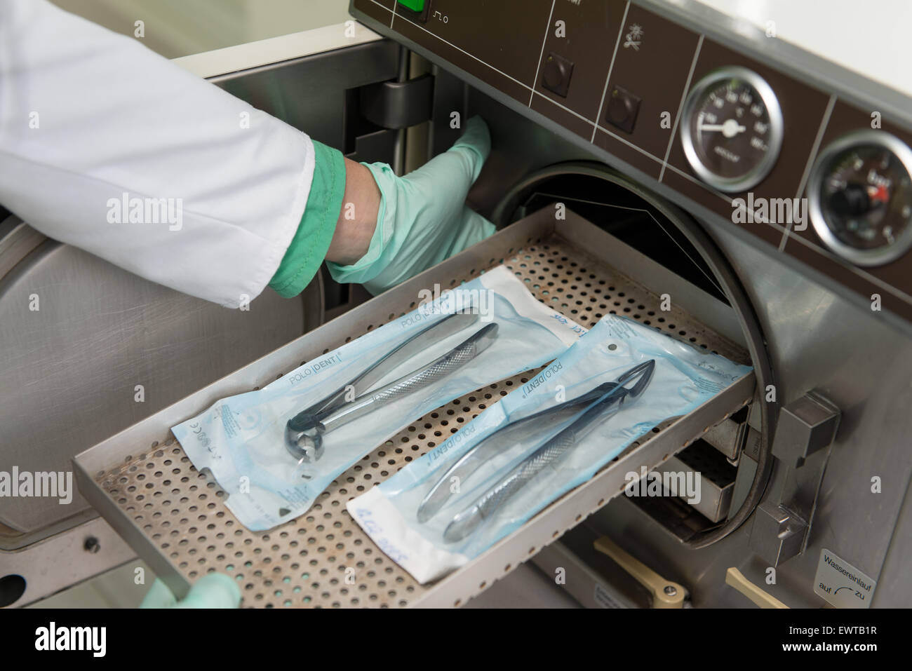 Young Female Dentist Places Medical Autoclave For Sterilising Surgical ...