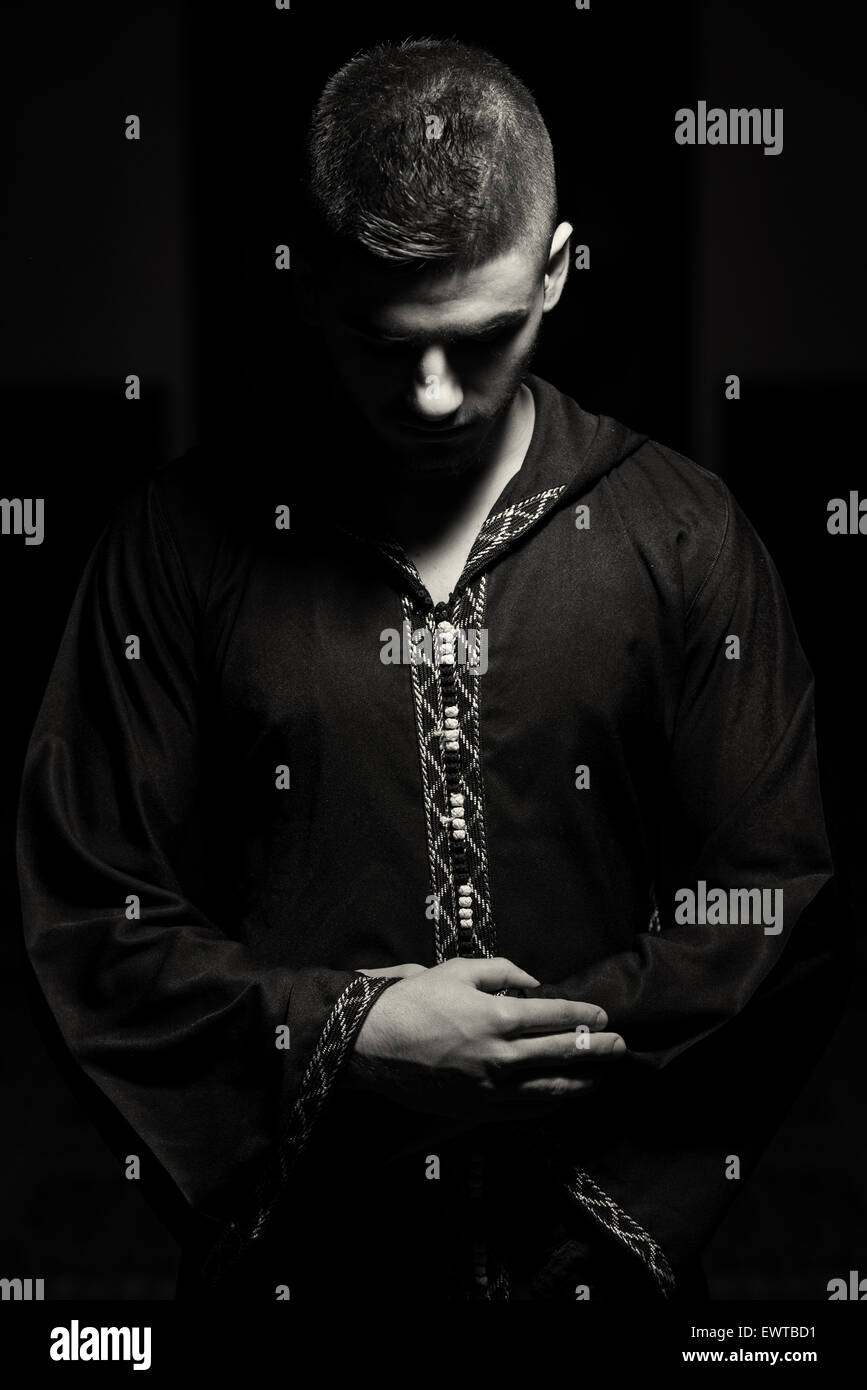 Young Muslim Guy Making Traditional Prayer To God While Wearing A ...