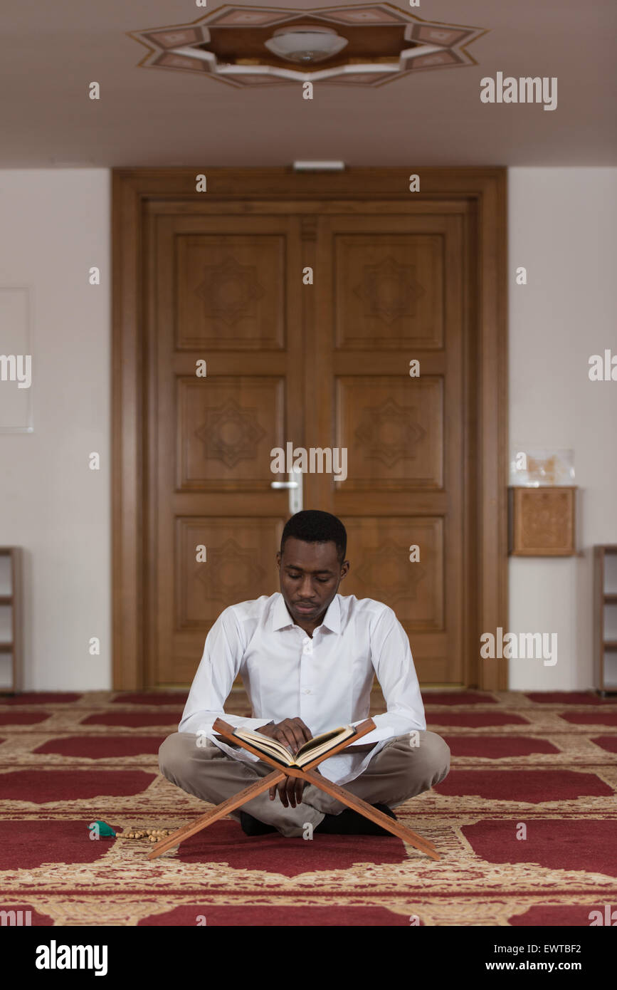 Black African Muslim Man Is Reading The Koran Stock Photo - Alamy