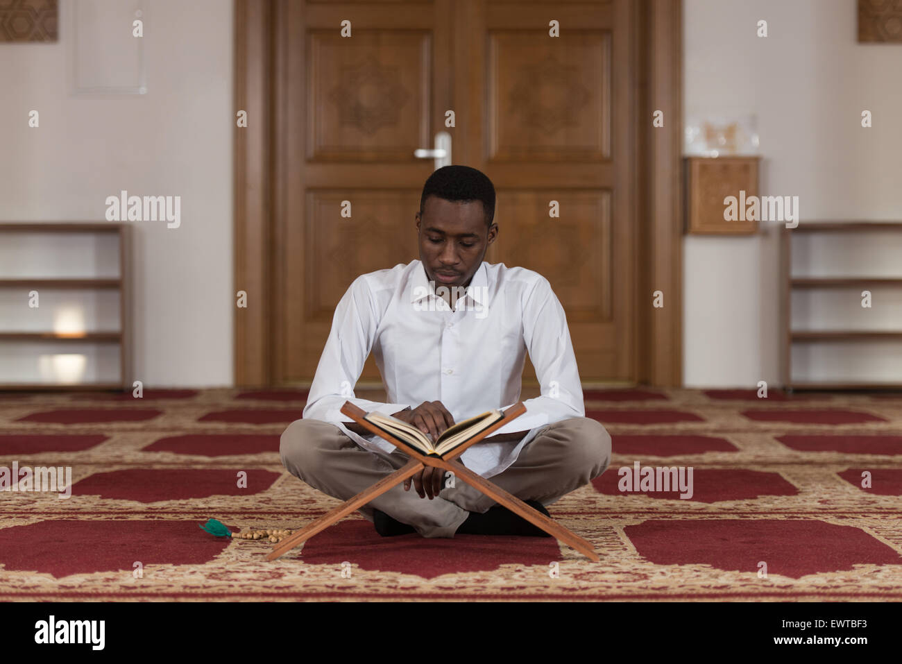 Black African Muslim Man Is Reading The Koran Stock Photo - Alamy