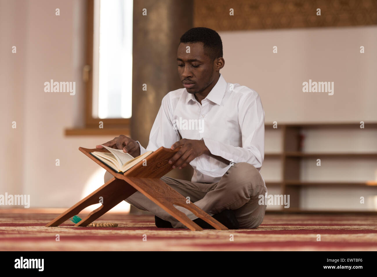 Black African Muslim Man Is Reading The Koran Stock Photo - Alamy
