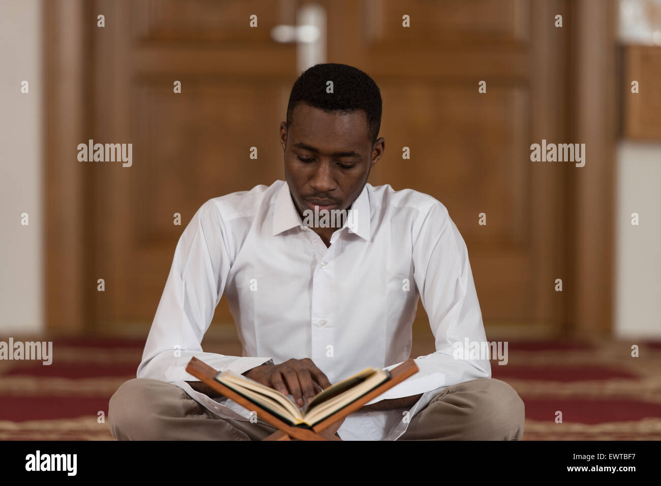 Black African Muslim Man Is Reading The Koran Stock Photo - Alamy