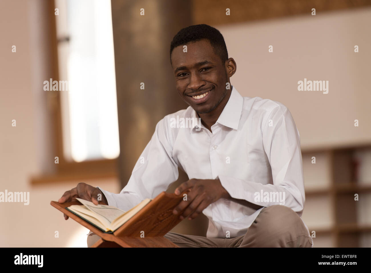 Black African Muslim Man Is Reading The Koran Stock Photo - Alamy
