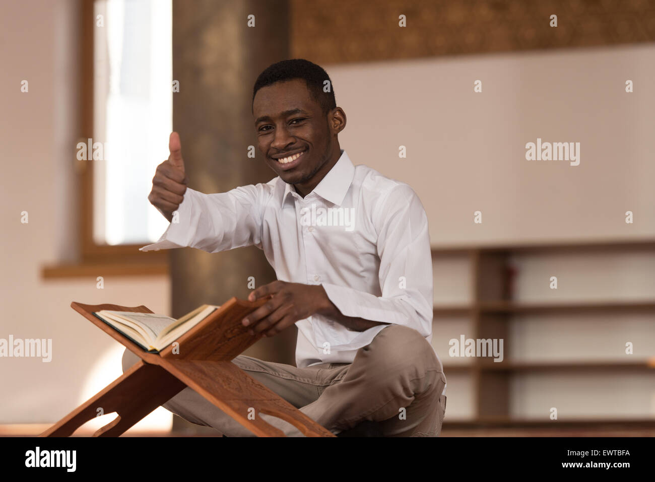 Black African Muslim Man Is Reading The Koran Stock Photo - Alamy
