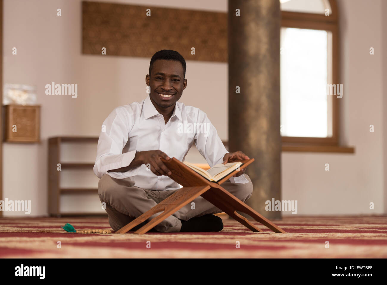 Black African Muslim Man Is Reading The Koran Stock Photo - Alamy