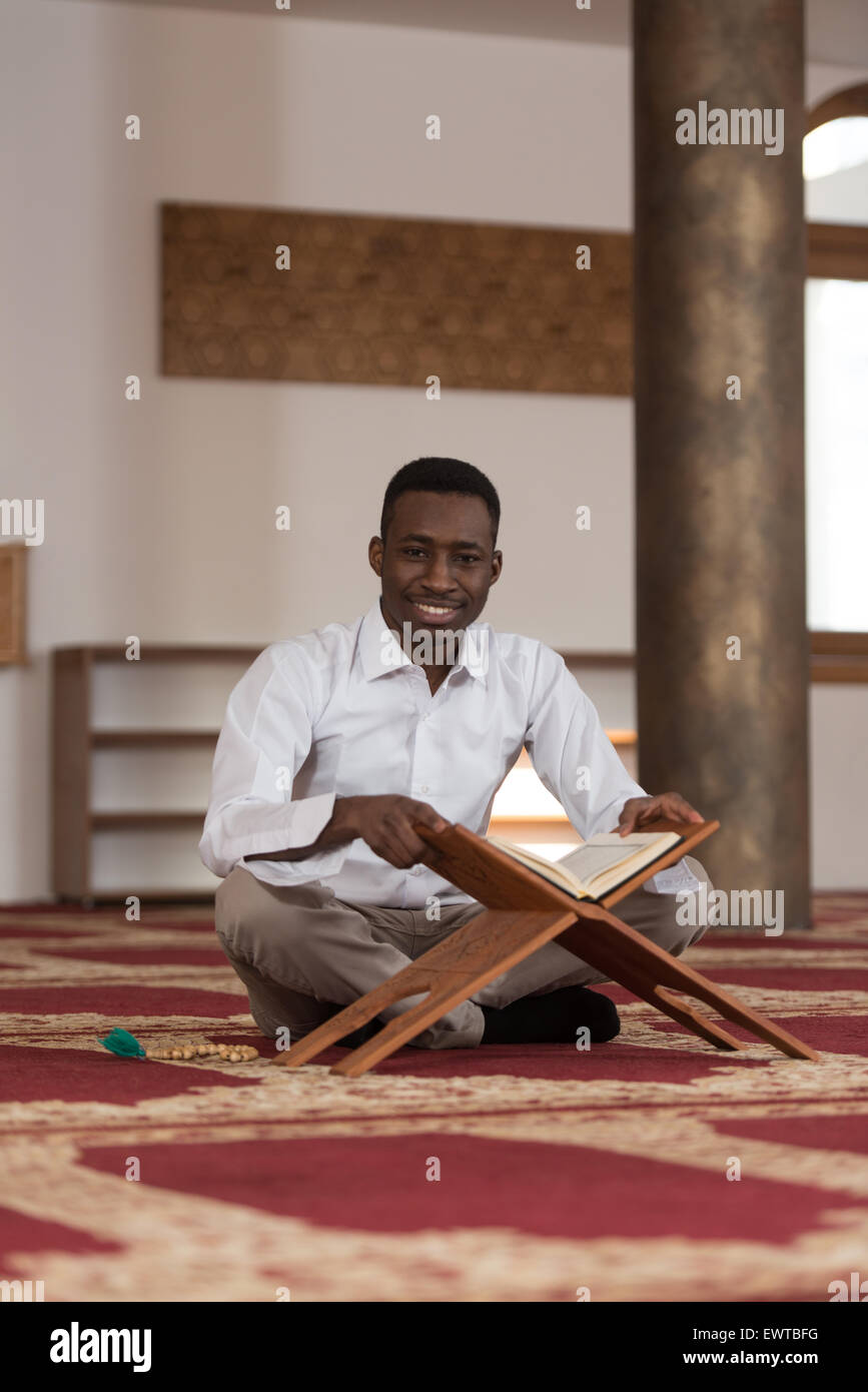 Black African Muslim Man Is Reading The Koran Stock Photo - Alamy