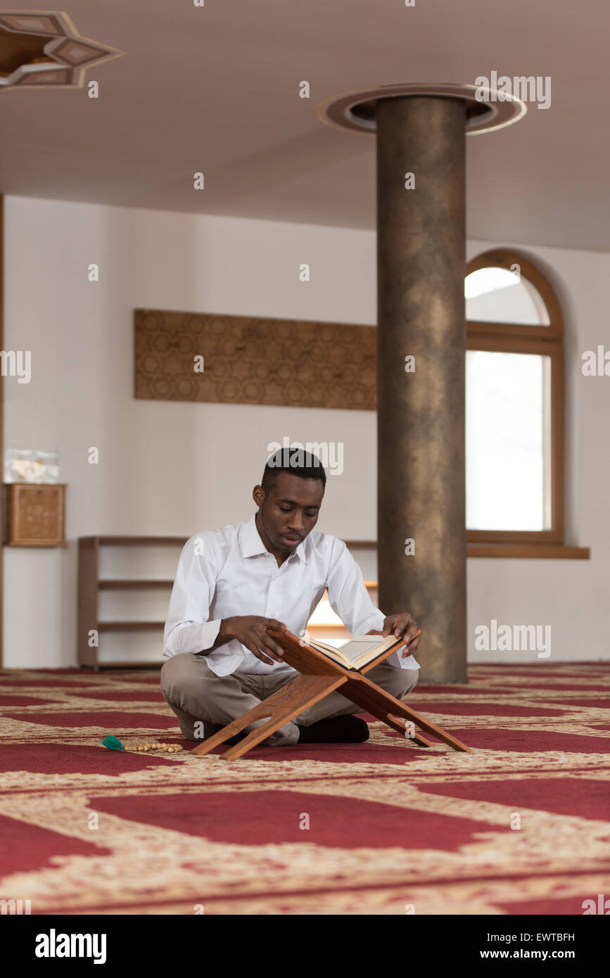 Black African Muslim Man Is Reading The Koran Stock Photo - Alamy