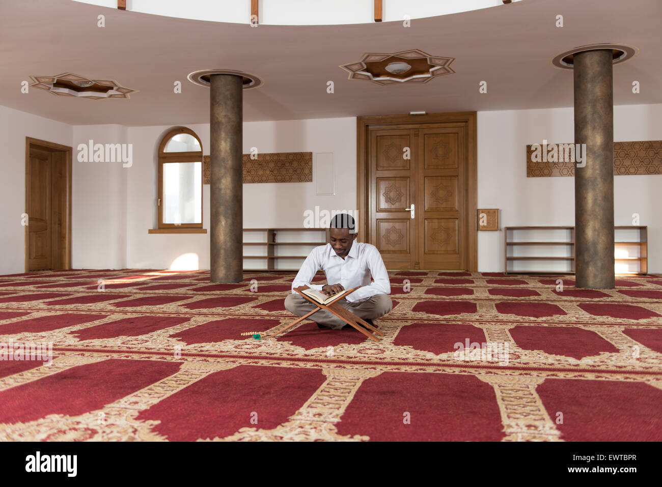 Black African Muslim Man Is Reading The Koran Stock Photo - Alamy