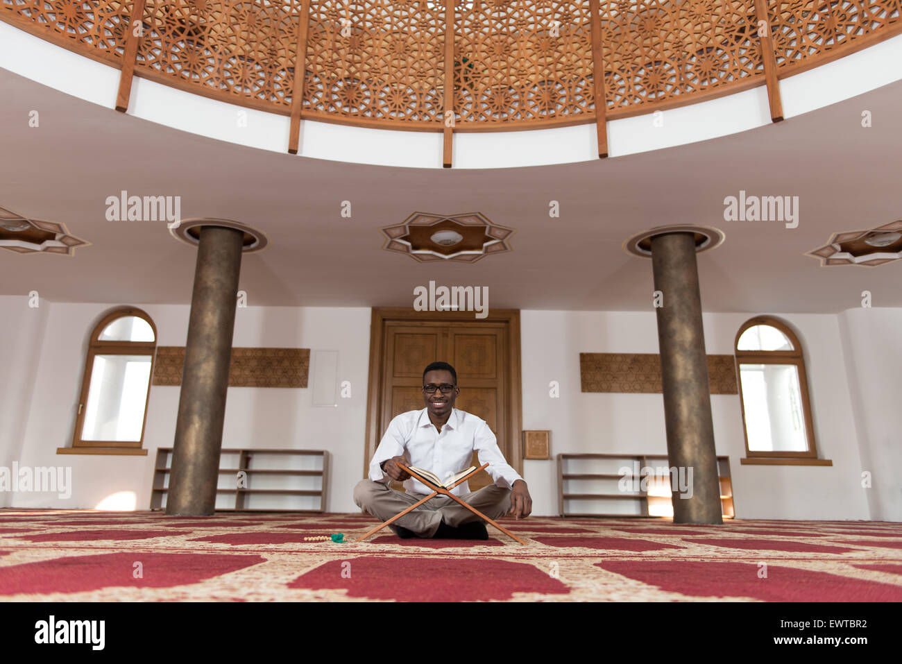 Black African Muslim Man Is Reading The Koran Stock Photo - Alamy
