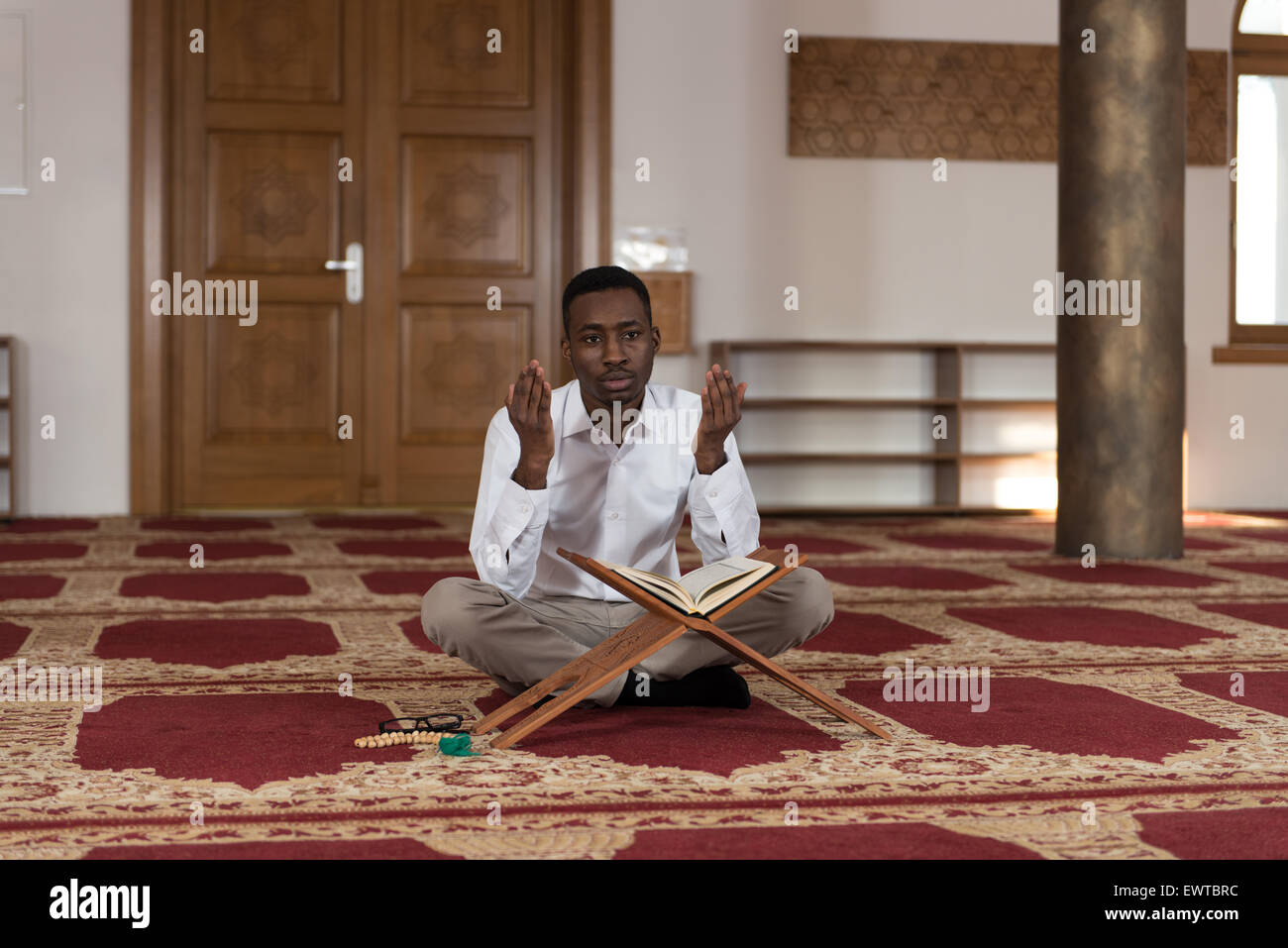 Black African Muslim Man Is Reading The Koran Stock Photo - Alamy