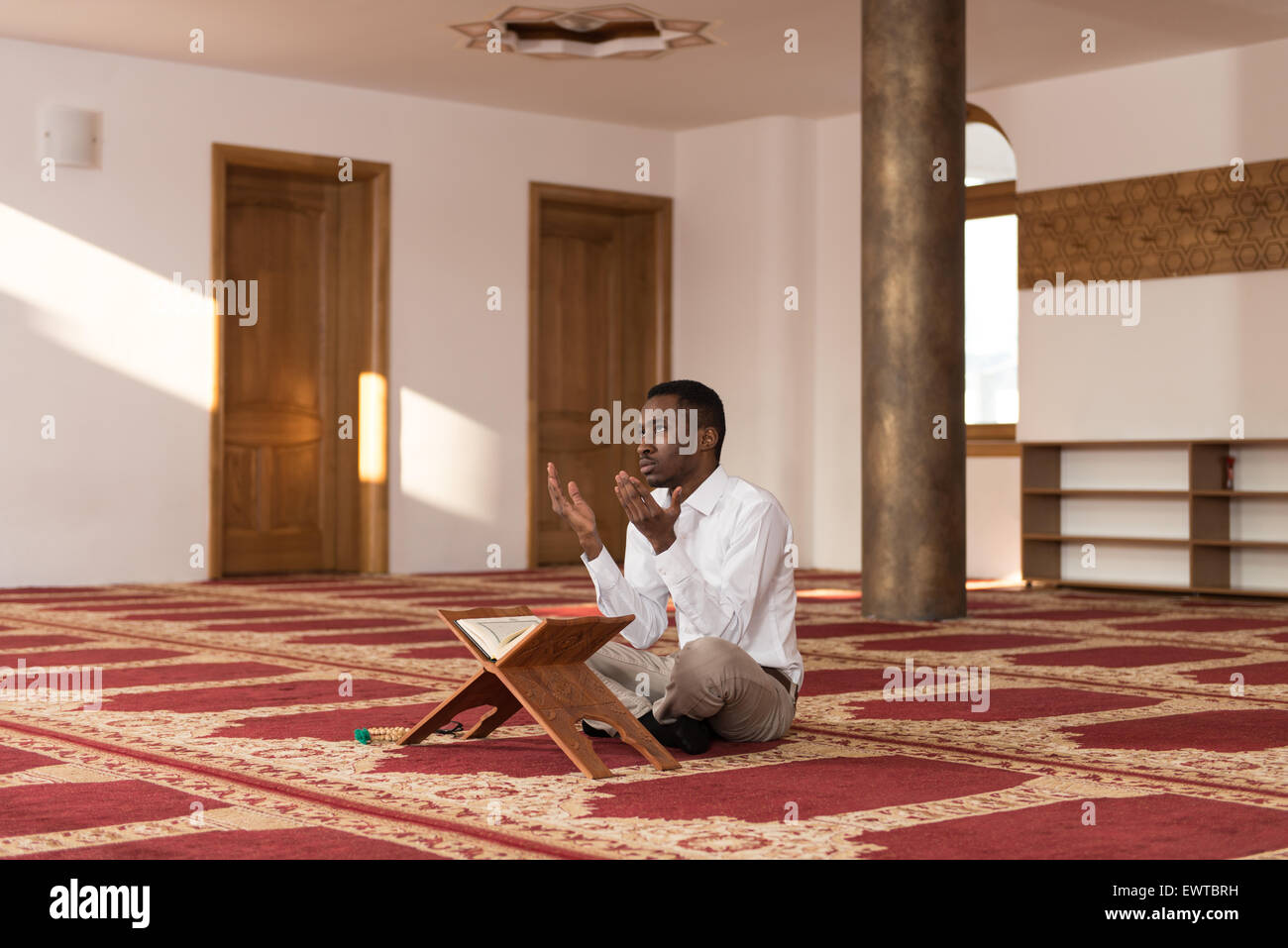 Black African Muslim Man Is Reading The Koran Stock Photo - Alamy