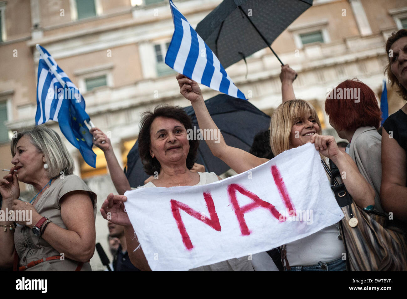 Athens, Greece. 30th June, 2015. Two women hold a banner outside the ...