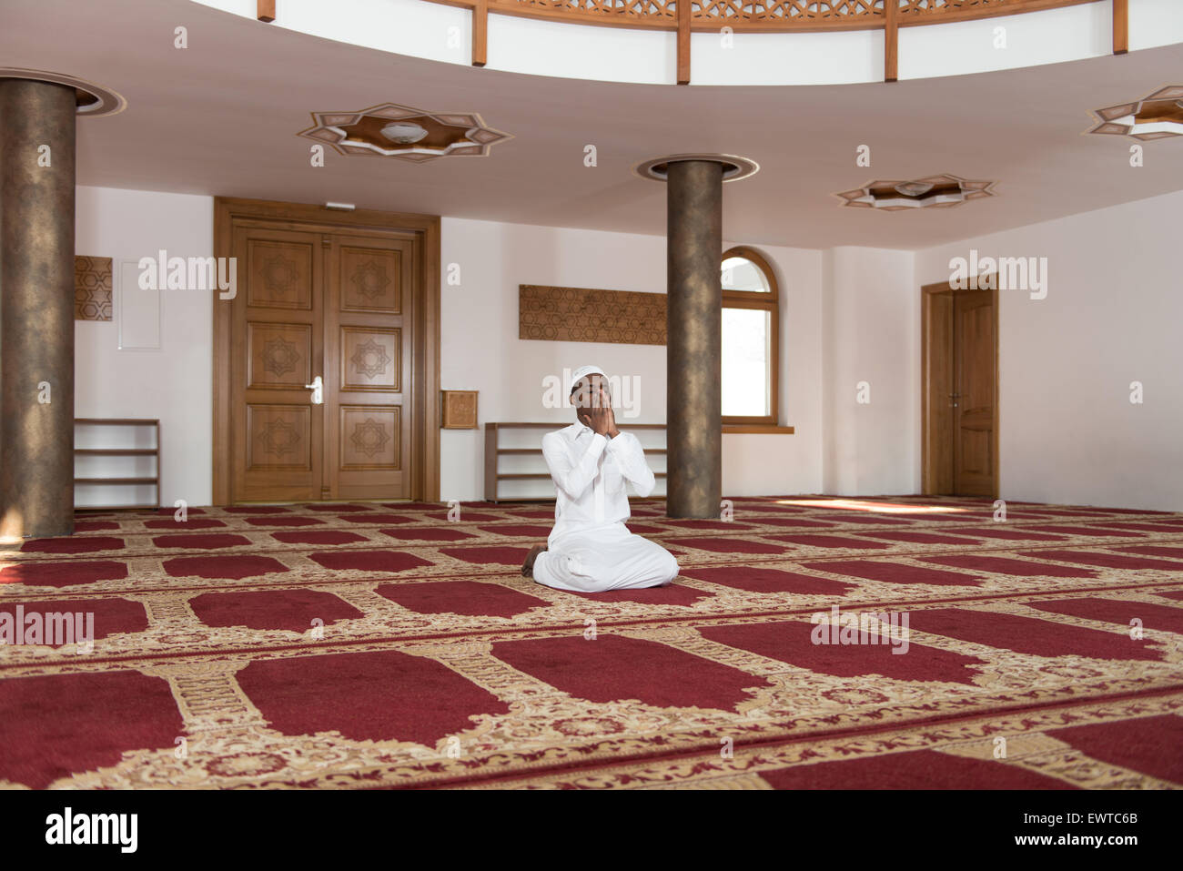 African Muslim Man Making Traditional Prayer To God While Wearing A ...