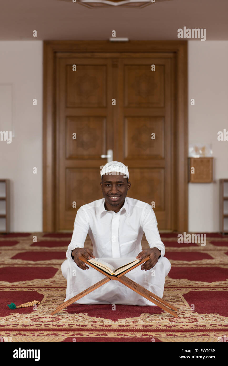 Black African Muslim Man Reading Holy Islamic Book Koran Stock Photo ...