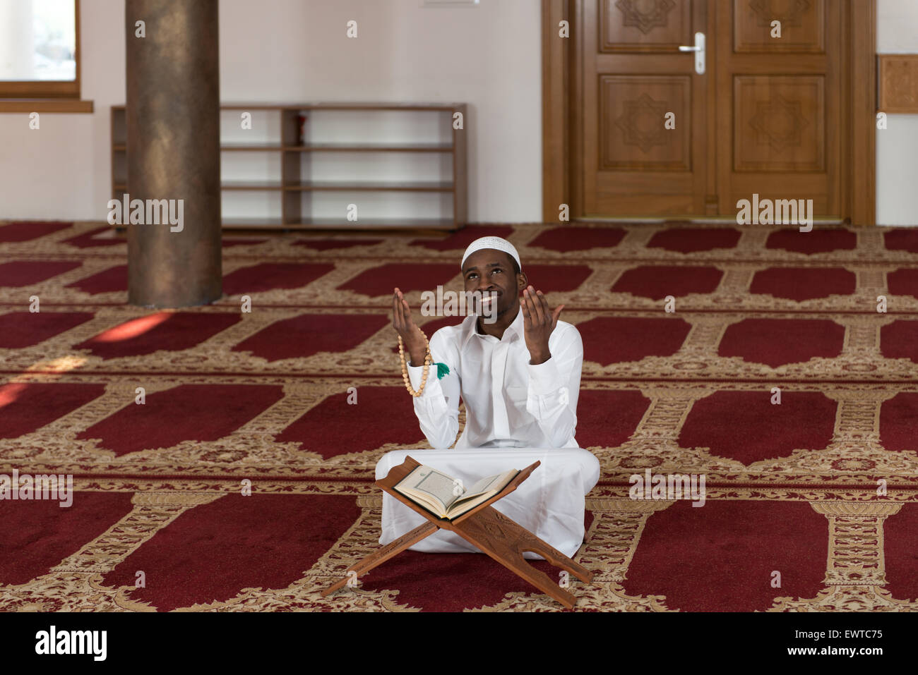 African Muslim Man Making Traditional Prayer To God While Wearing A ...