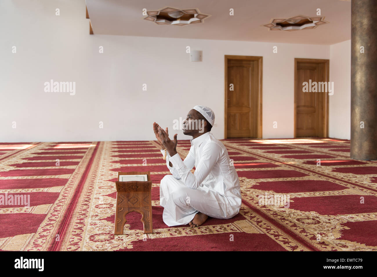 African Muslim Man Making Traditional Prayer To God While Wearing A ...