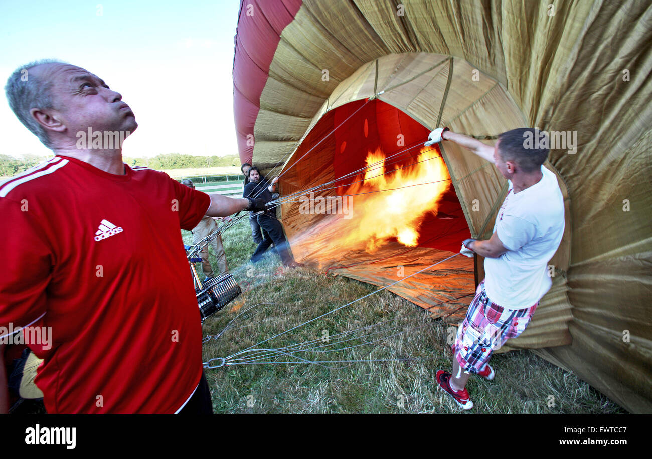 Helpers hold on to the 68 m tall hot-air balloon shaped like the ...