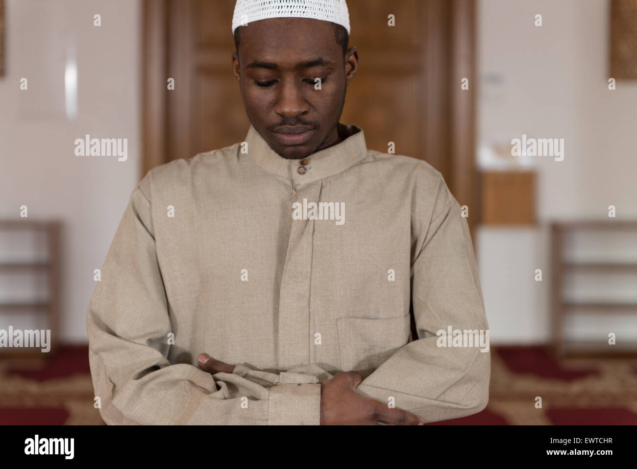 African Muslim Man Making Traditional Prayer To God While Wearing A ...