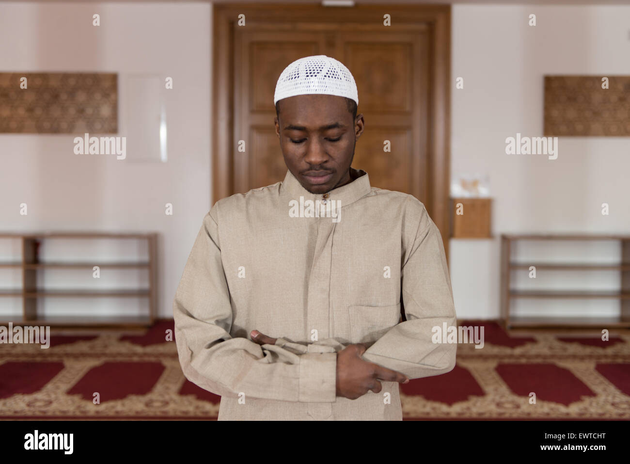 African Muslim Man Making Traditional Prayer To God While Wearing A ...