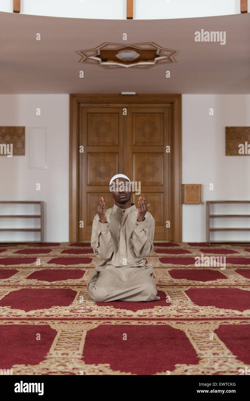 African Muslim Man Making Traditional Prayer To God While Wearing A ...
