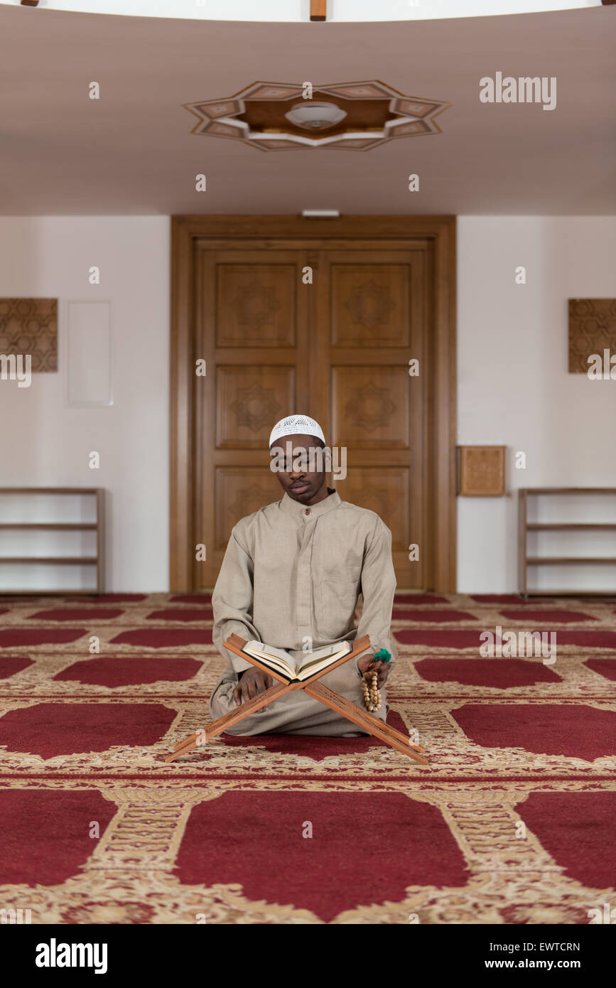 Black African Muslim Man Reading Holy Islamic Book Koran Stock Photo ...
