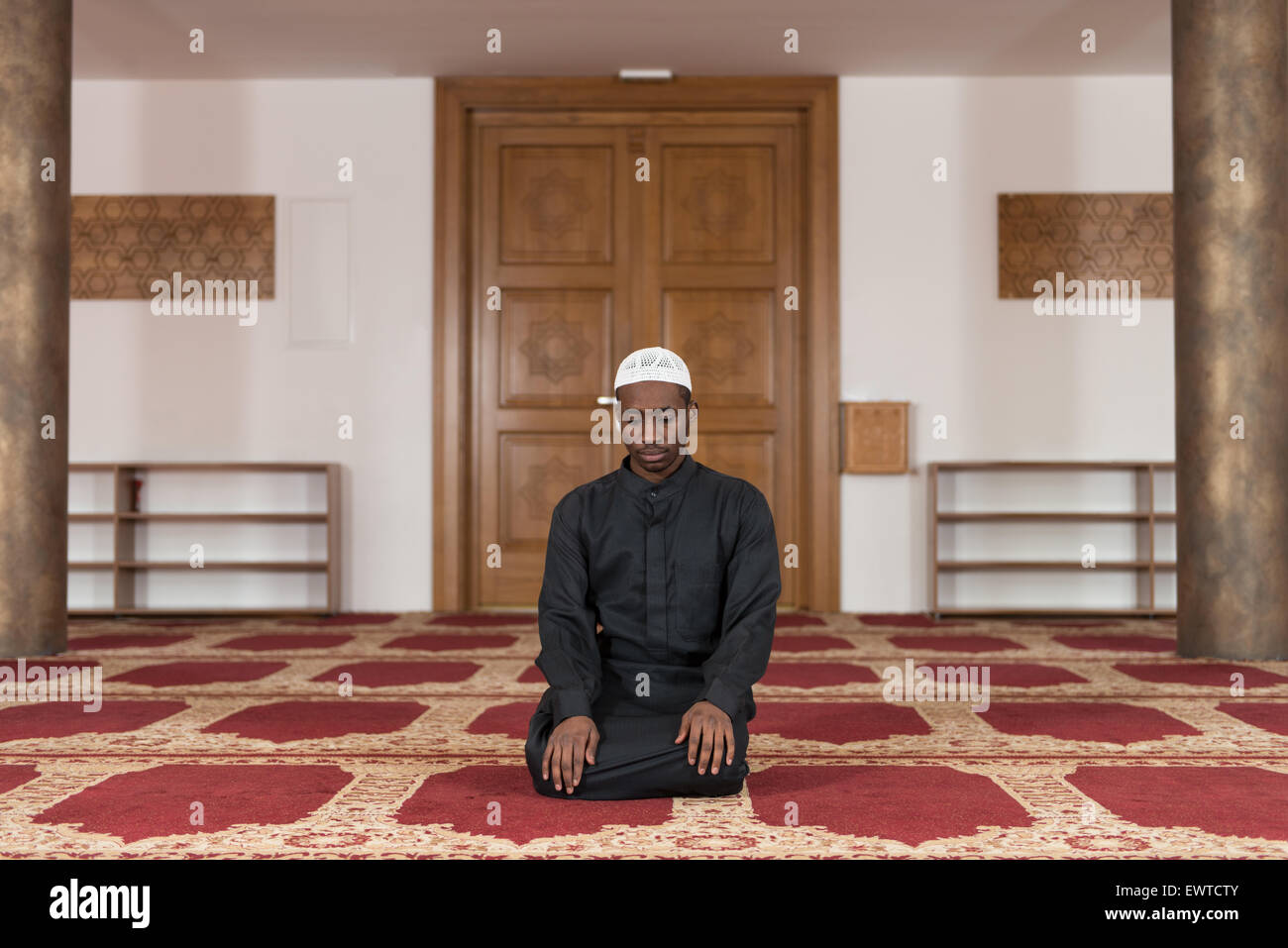 African Muslim Man Making Traditional Prayer To God While Wearing A ...