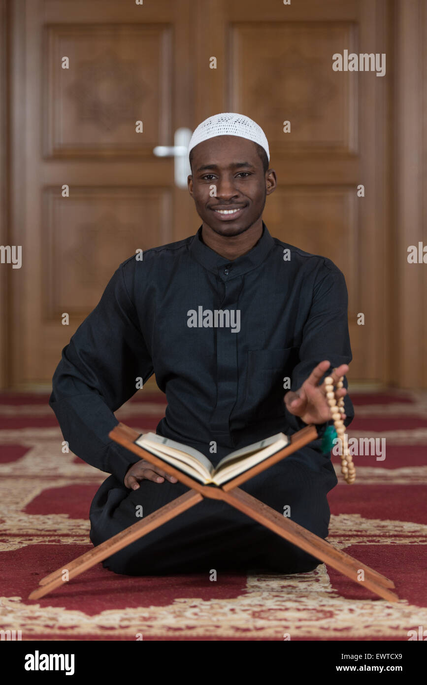 Black African Muslim Man Reading Holy Islamic Book Koran Stock Photo ...