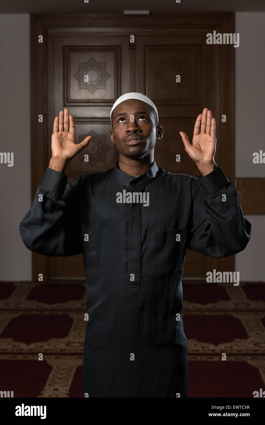 African Muslim Man Making Traditional Prayer To God While Wearing A ...