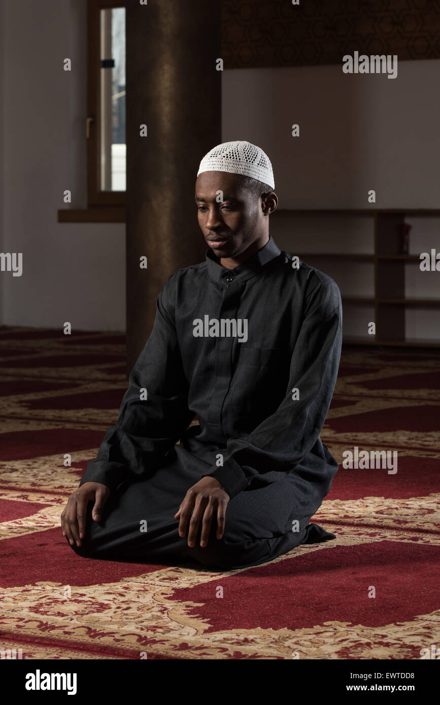 African Muslim Man Making Traditional Prayer To God While Wearing A ...