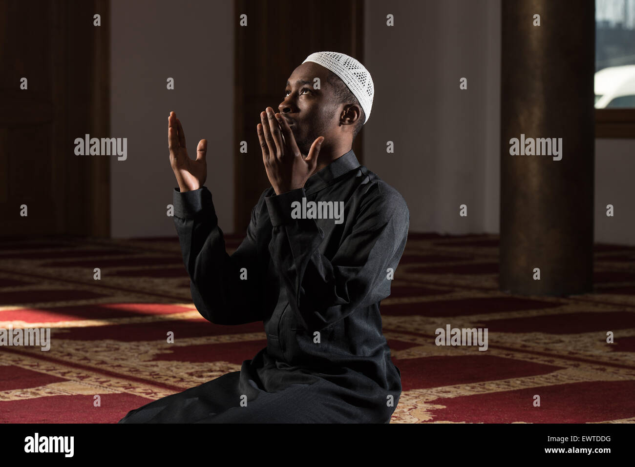 African Muslim Man Making Traditional Prayer To God While Wearing A ...