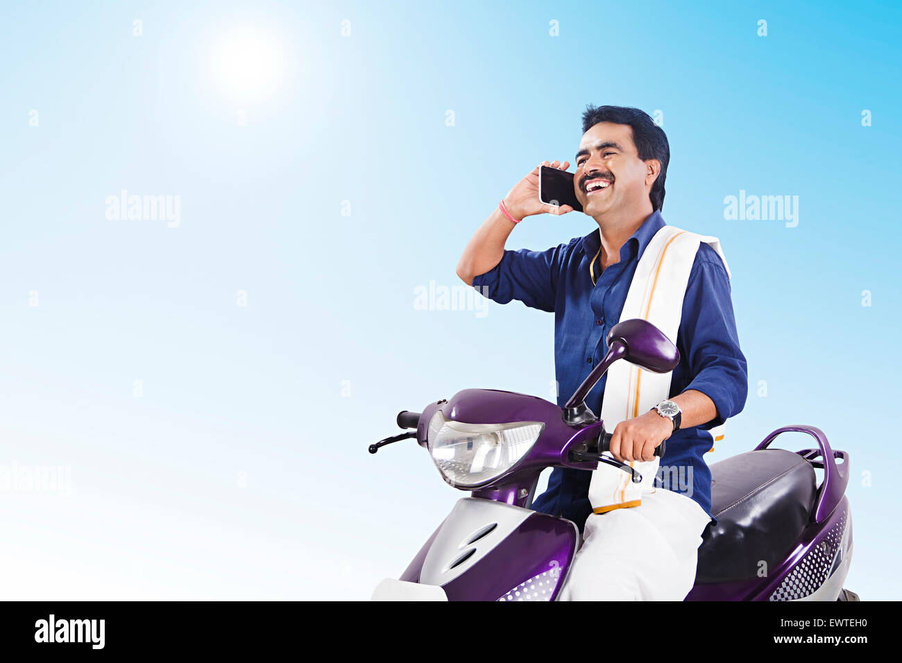 1 South Indian man Riding Scooty and talking Cell Phone Stock Photo - Alamy
