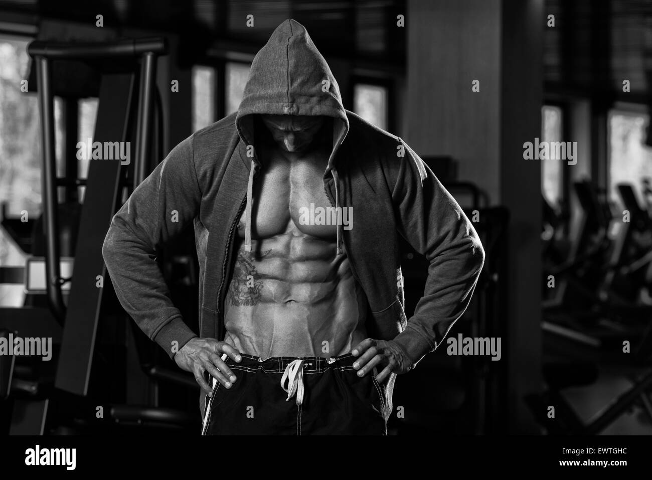 Portrait Of A Physically Fit Man In Hoodie - In Modern Fitness Center ...
