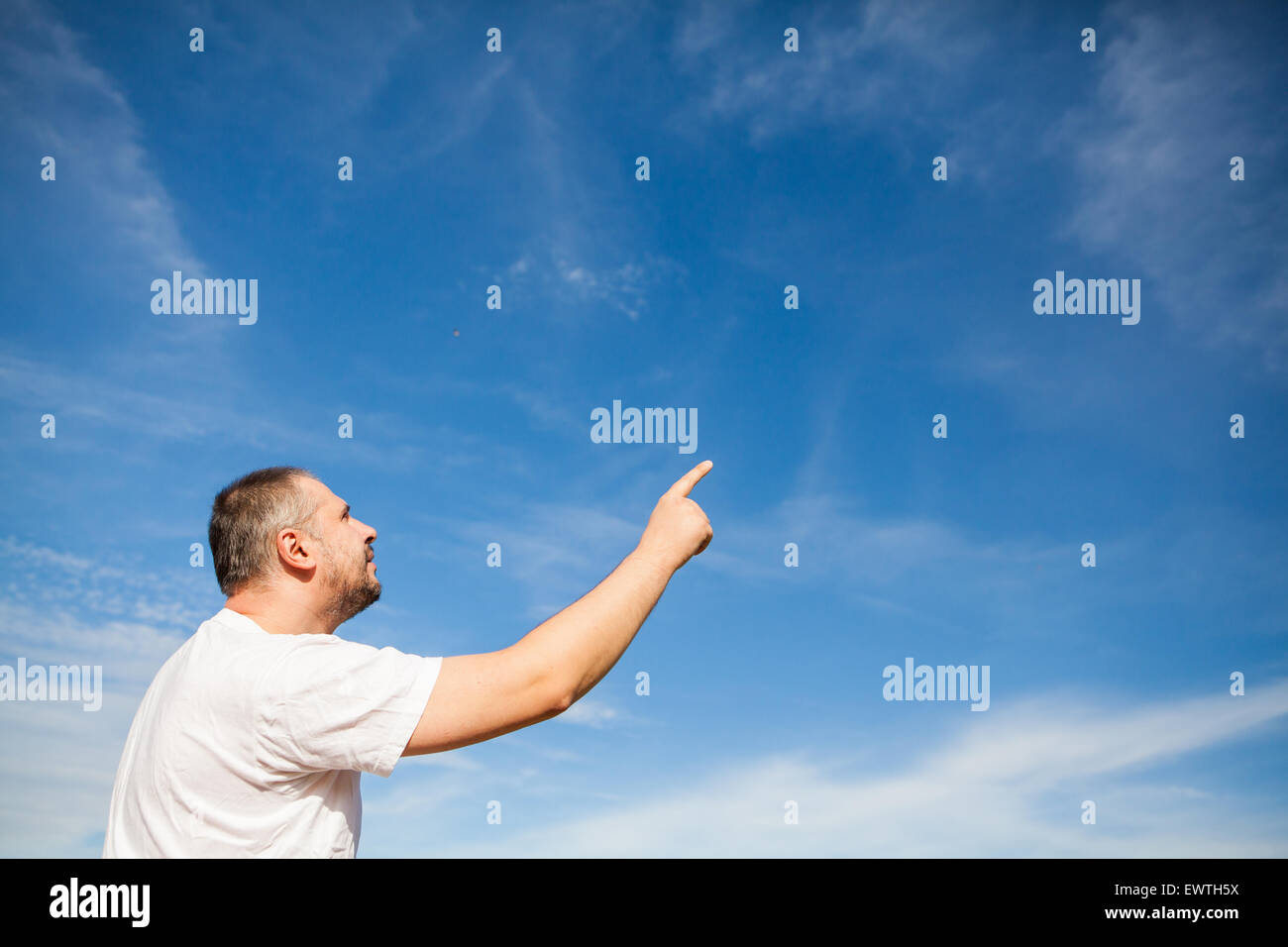 Side portrait low angle view of a man with beard standing and looking ...