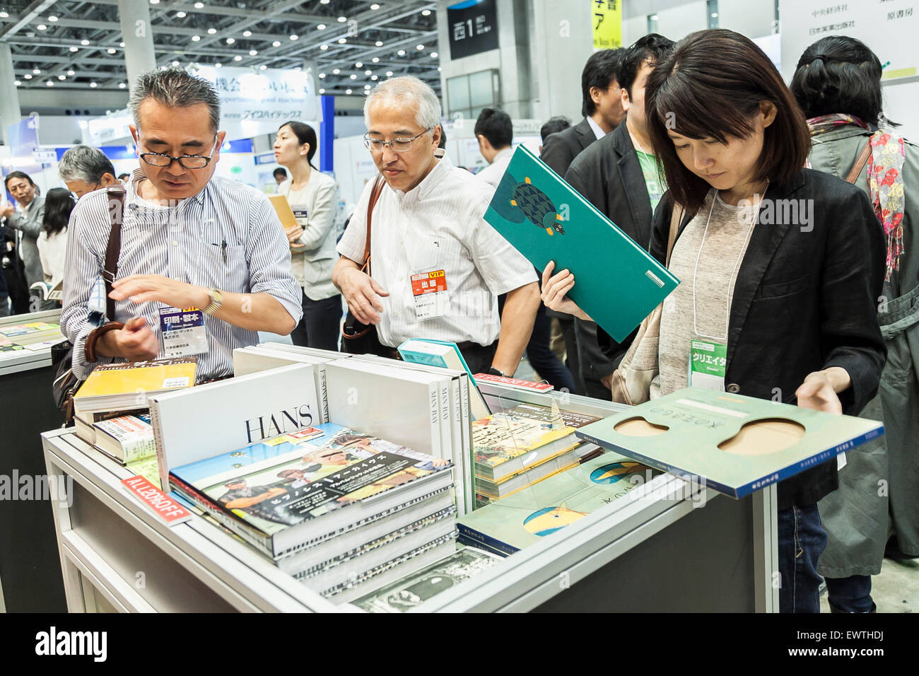 Visitors look at the latest products and services from the publishing ...