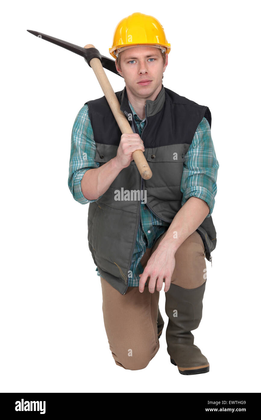 Man with pick-ax knelt on one knee Stock Photo - Alamy
