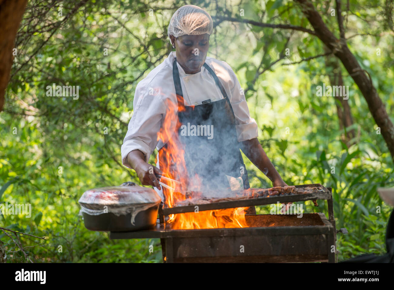 Woman cooking on grill hi-res stock photography and images - Alamy