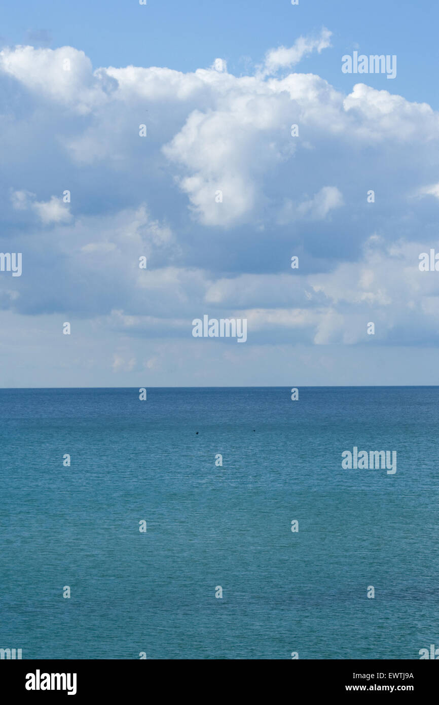 Pastel colours of limpid aegean sea waters and clouds in the sky viewed ...
