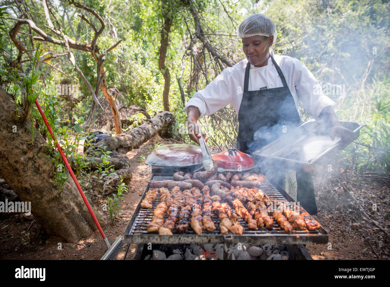 Woman cooking on grill hi-res stock photography and images - Alamy