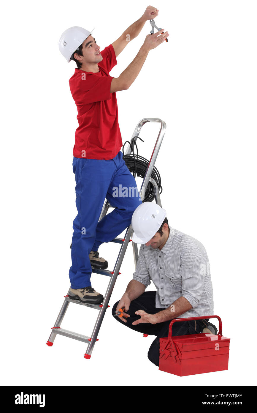 Two electricians working Stock Photo - Alamy