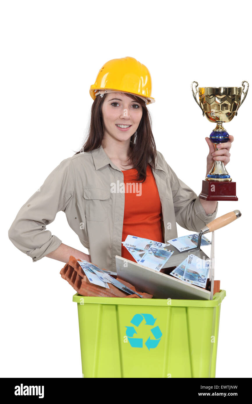 Female laborer holding gold cup Stock Photo - Alamy