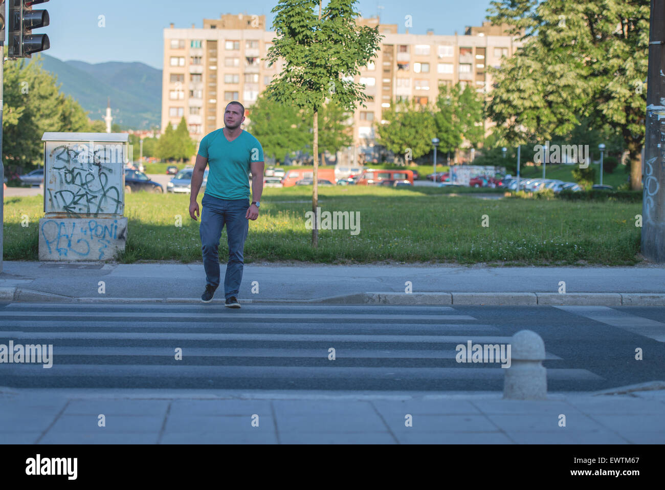 young man walking on zebra crossing Stock Photo - Alamy