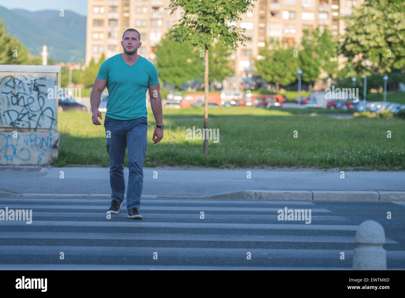 young man walking on zebra crossing Stock Photo - Alamy