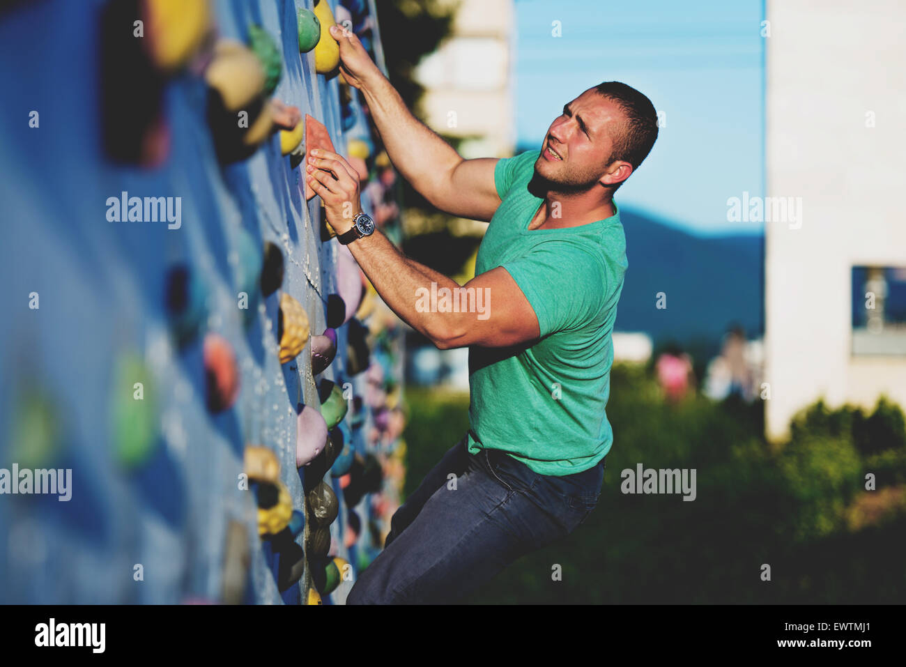 young man climbing wall rock outdoors Stock Photo - Alamy