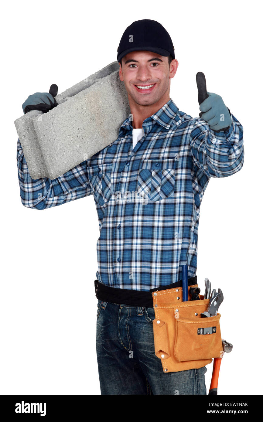 Builder carrying building block Stock Photo - Alamy
