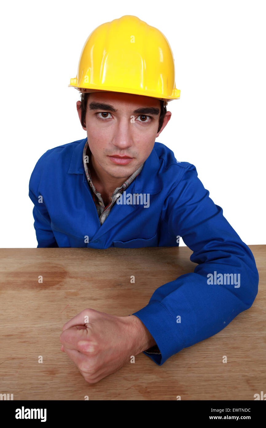 Builder hitting table with fist Stock Photo - Alamy