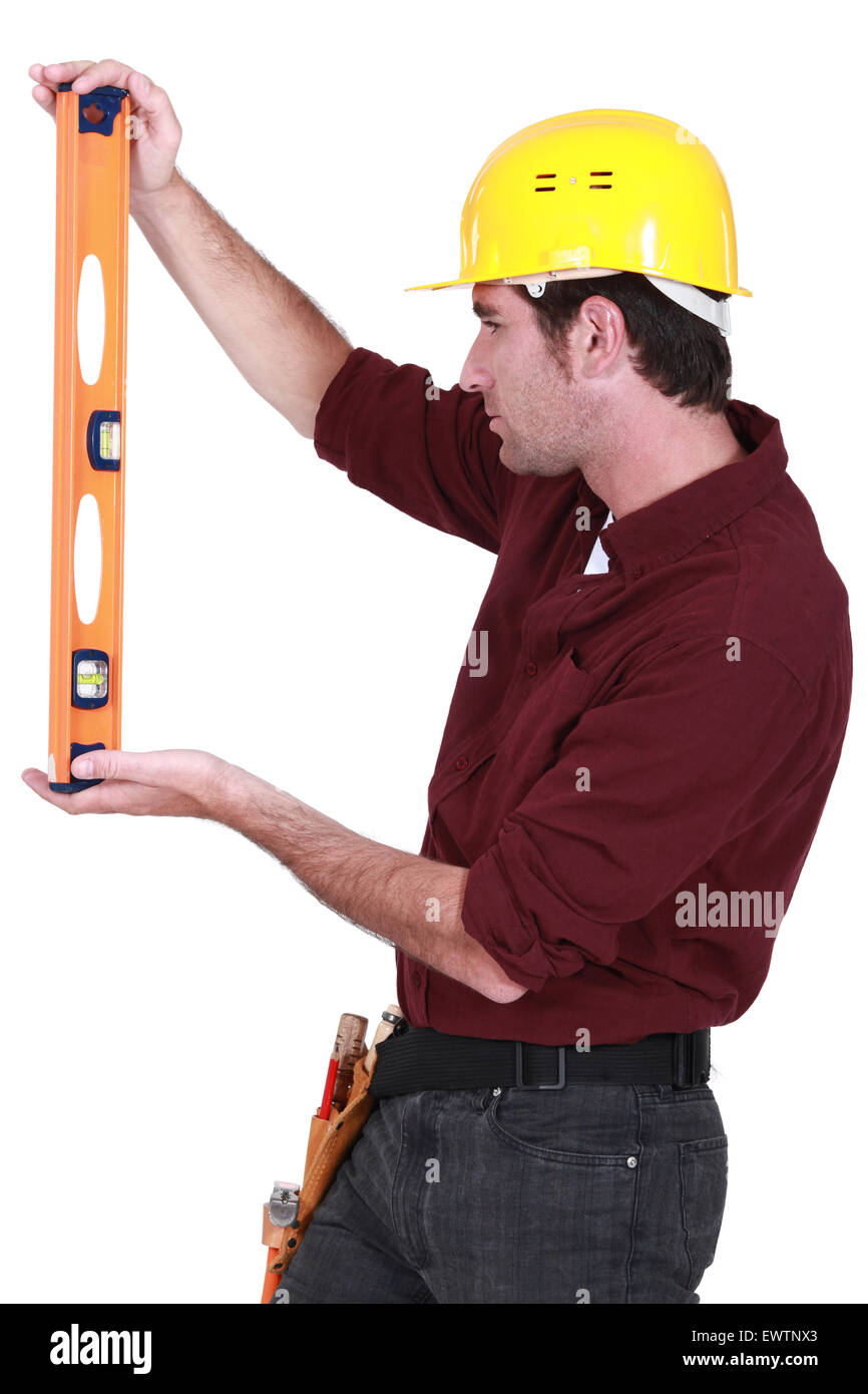 Handyman using spirit-level Stock Photo - Alamy